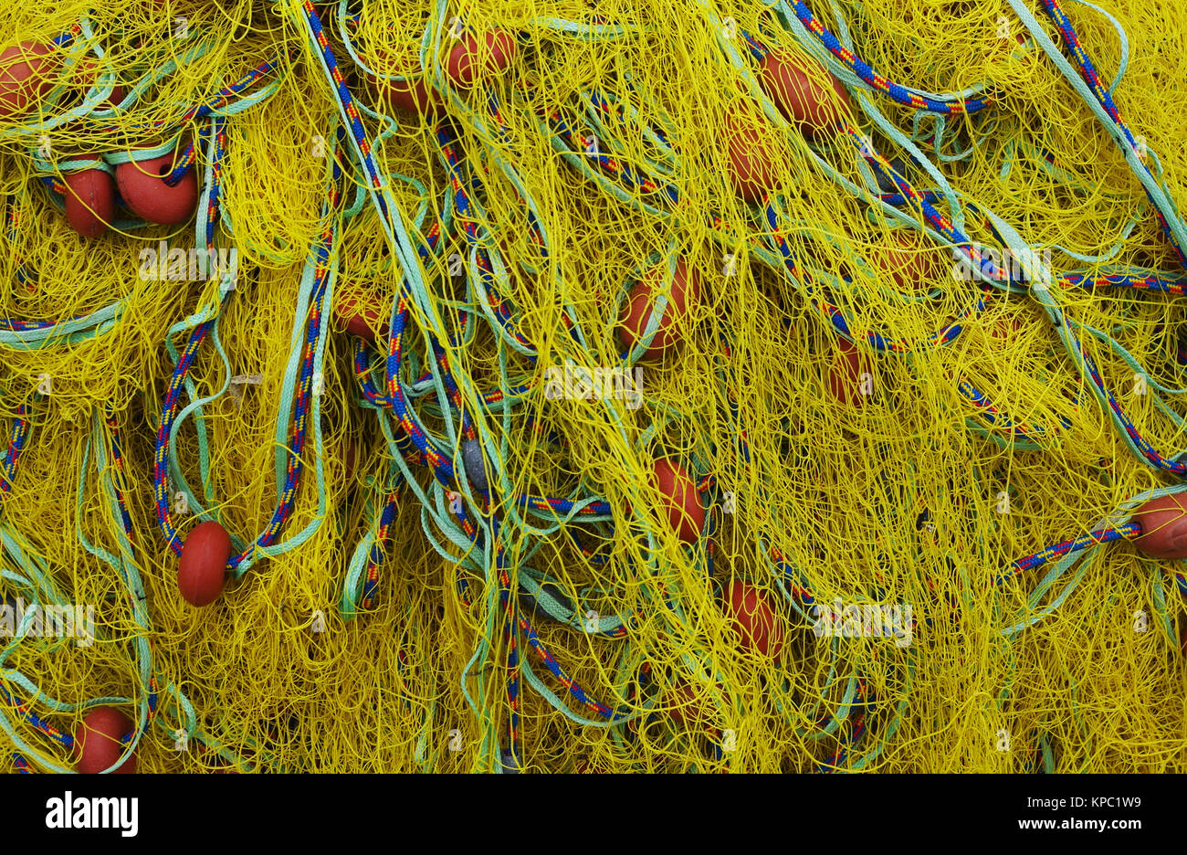 Bright yellow fishing net in a greek harbor Stock Photo - Alamy