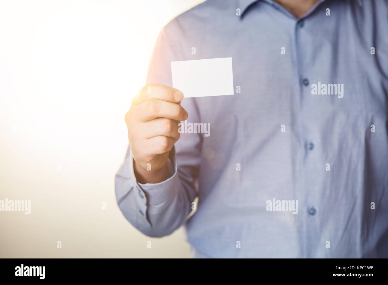 Man holding white business card Stock Photo - Alamy