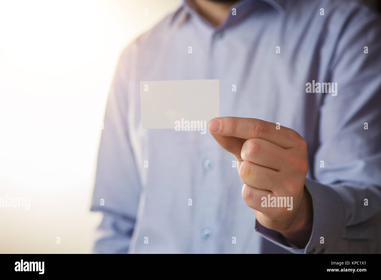 Man holding white business card Stock Photo - Alamy