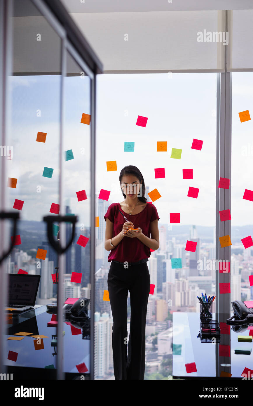 Busy Business Woman Writing Tasks On Adhesive Notes Stock Photo - Alamy