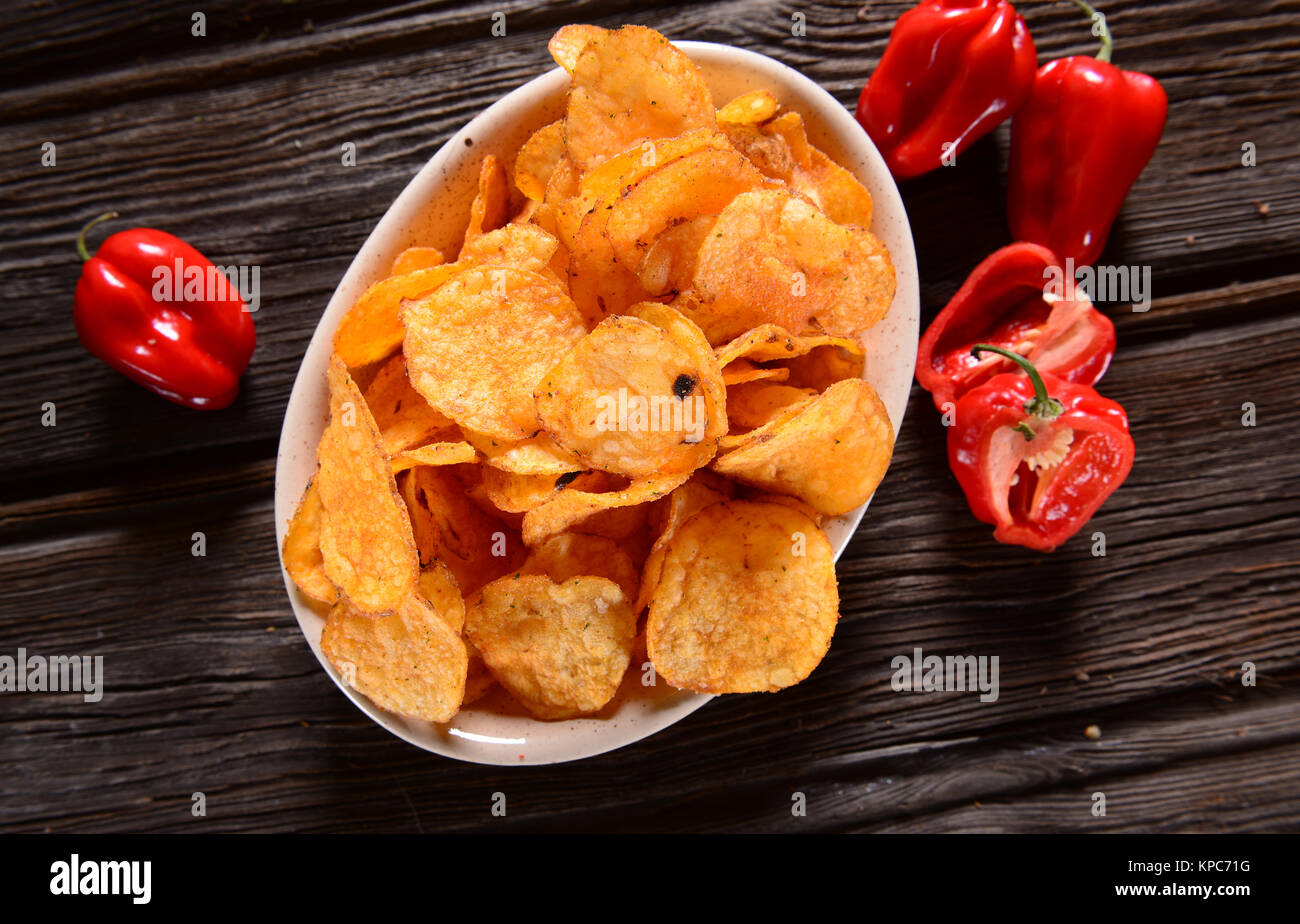 Paprika Potato Chips on rustic background Stock Photo - Alamy