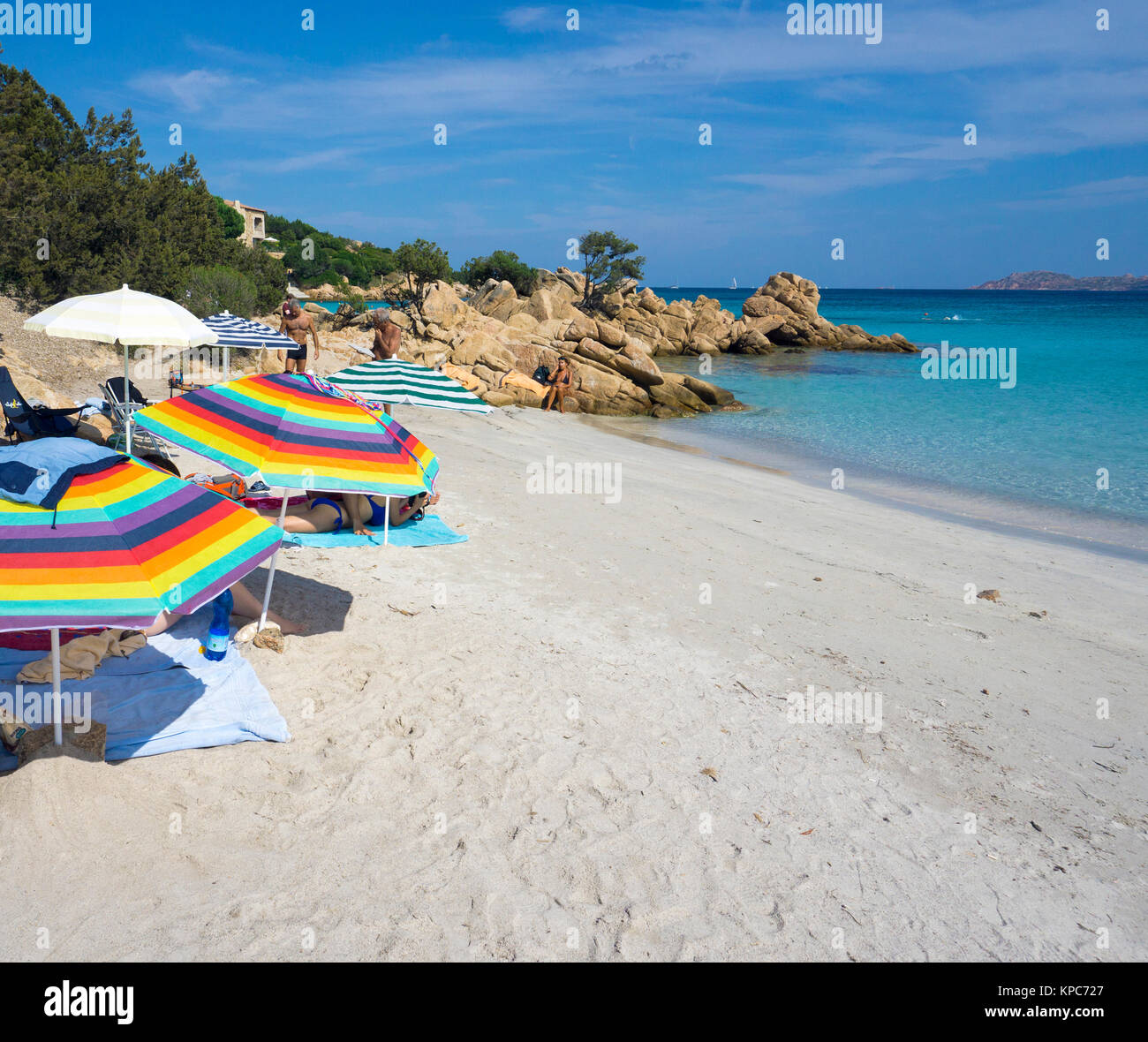 People at idyllic beach with turquoise colour sea and granite rocks at ...