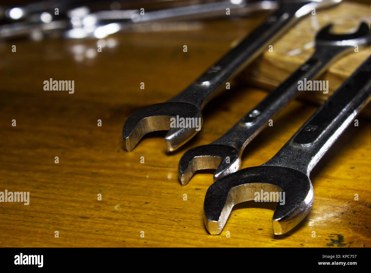 Horizontal photo of a set spanner on a wood table Stock Photo - Alamy