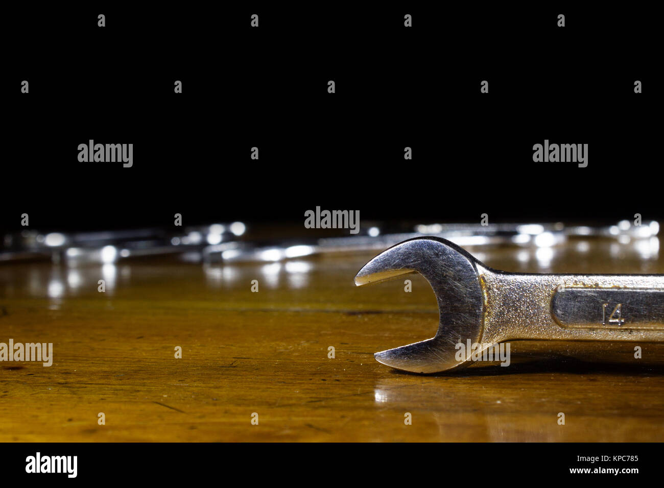 Horizontal photo of a spanner on a wood table Stock Photo - Alamy