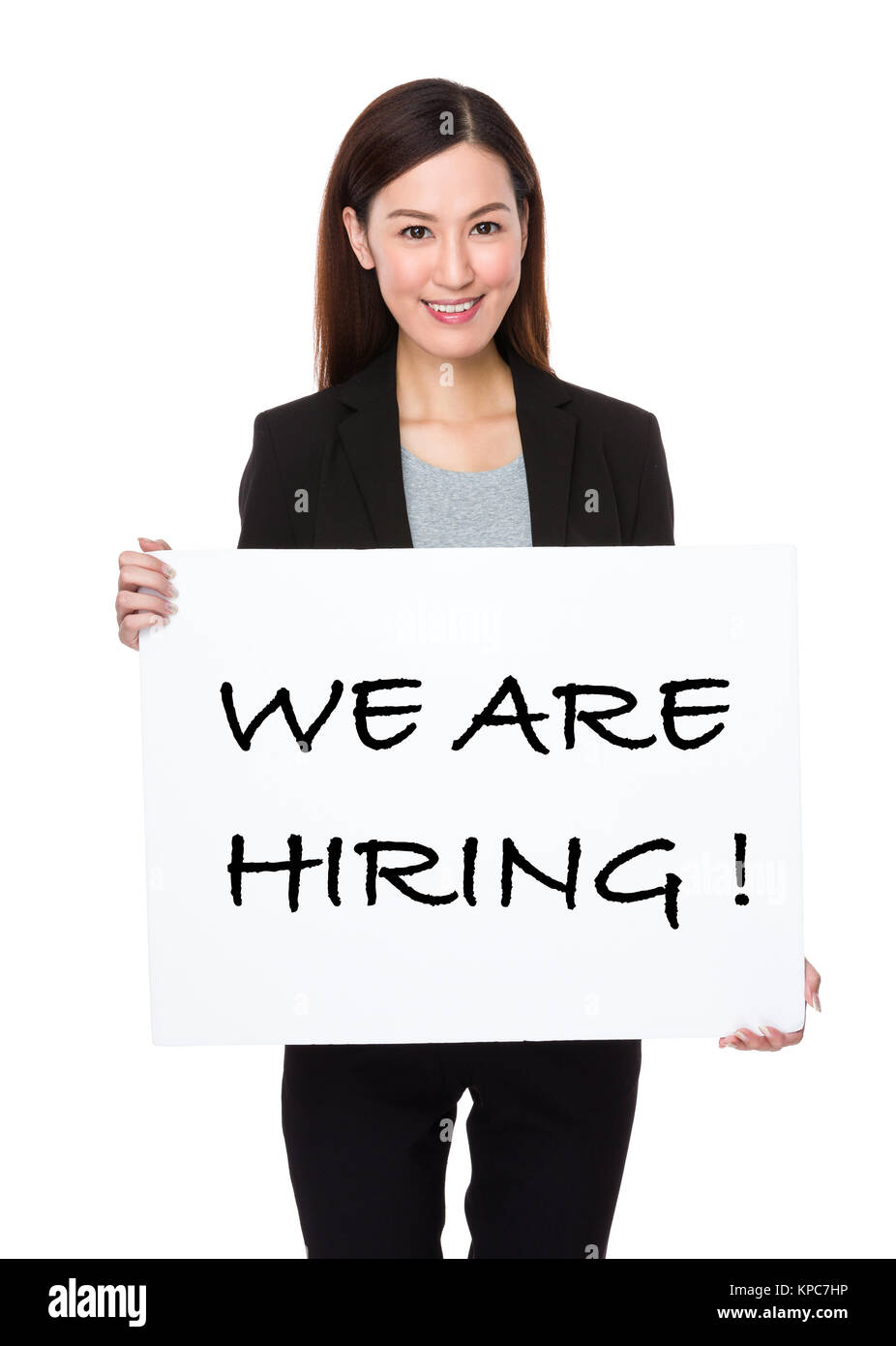 Young businesswoman showing a poster showing with we are hiring phrases ...