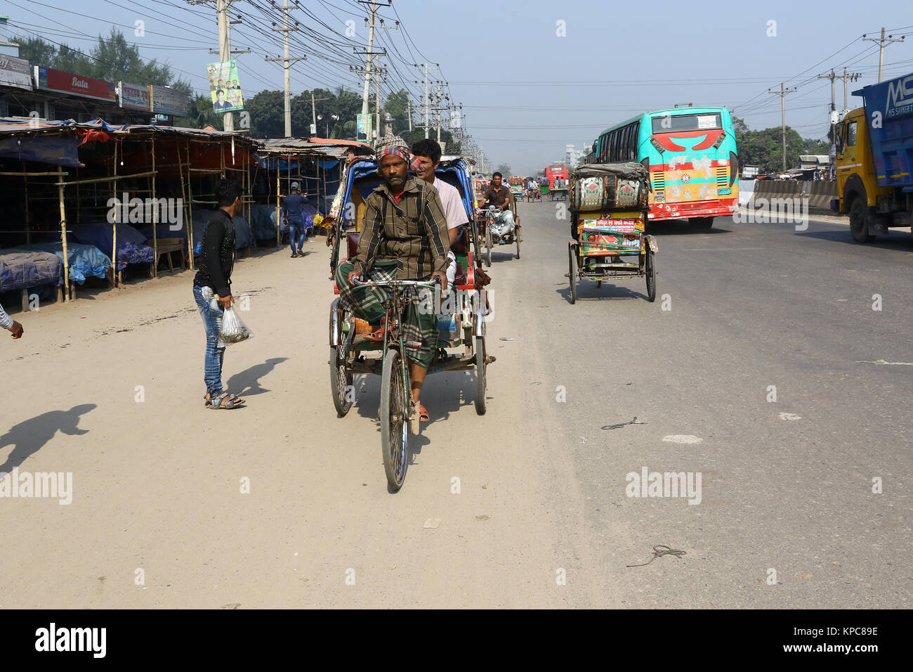 A battery-run rickshaw plying the Dhaka-Aricha highway near Amin Bazar ...