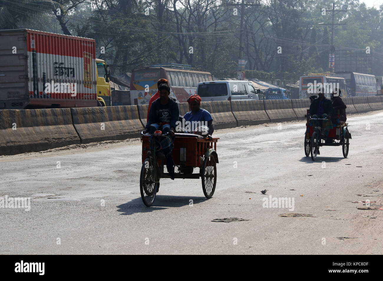 A battery-run rickshaw plying the Dhaka-Aricha highway near Amin Bazar ...