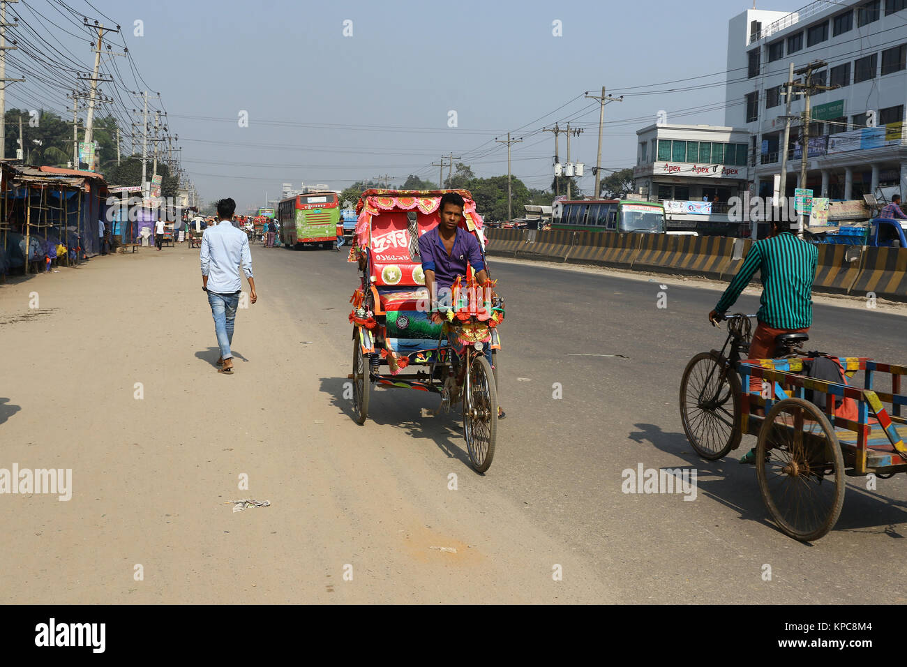 A battery-run rickshaw plying the Dhaka-Aricha highway near Amin Bazar ...