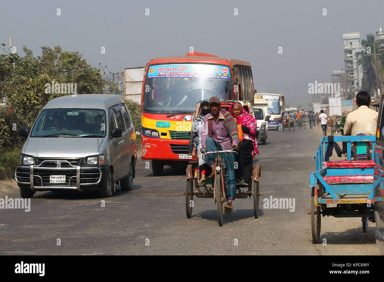A battery-run rickshaw plying the Dhaka-Aricha highway near Amin Bazar ...
