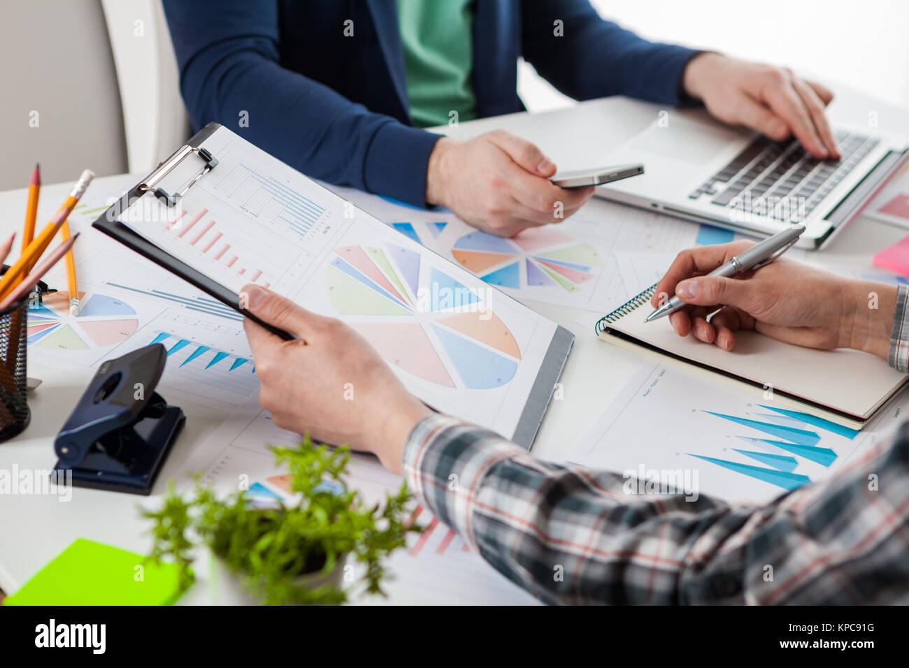 Business people discussing the charts and graphs showing the results of ...