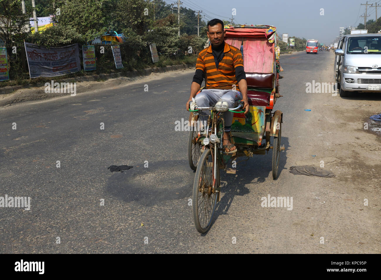 A battery-run rickshaw plying the Dhaka-Aricha highway near Amin Bazar ...