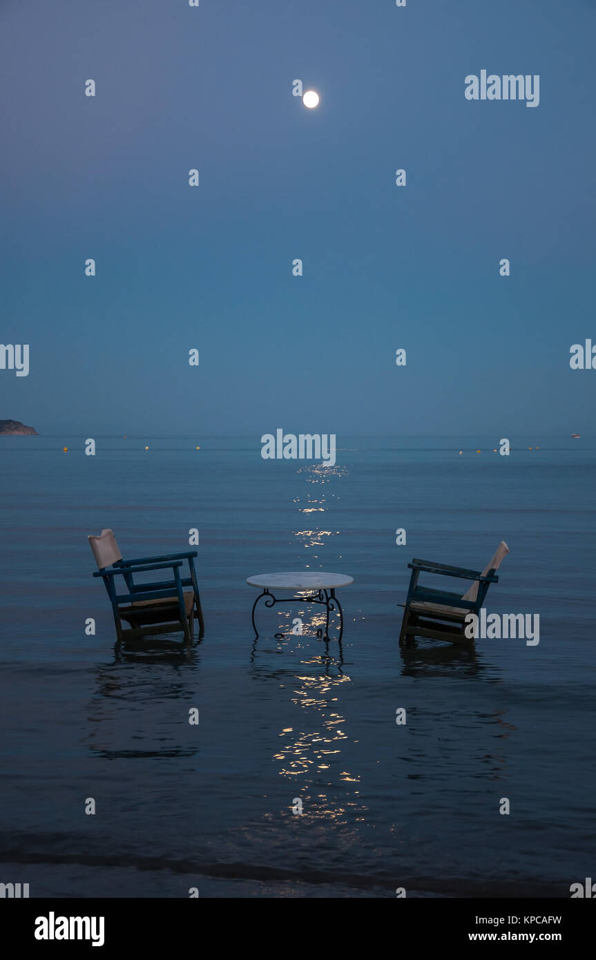 table in the sea at night Stock Photo - Alamy