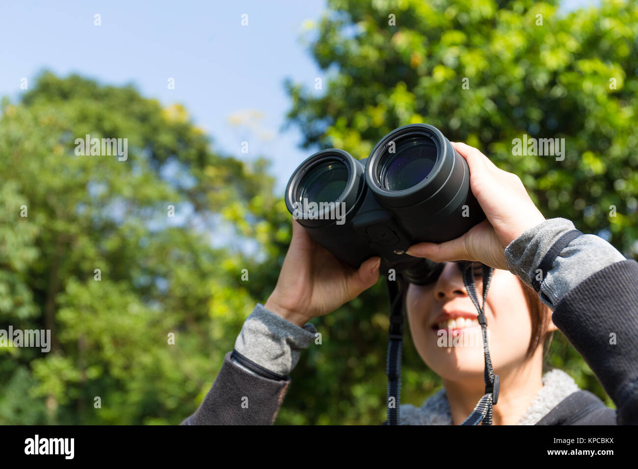 Woman use of the binoculars Stock Photo - Alamy