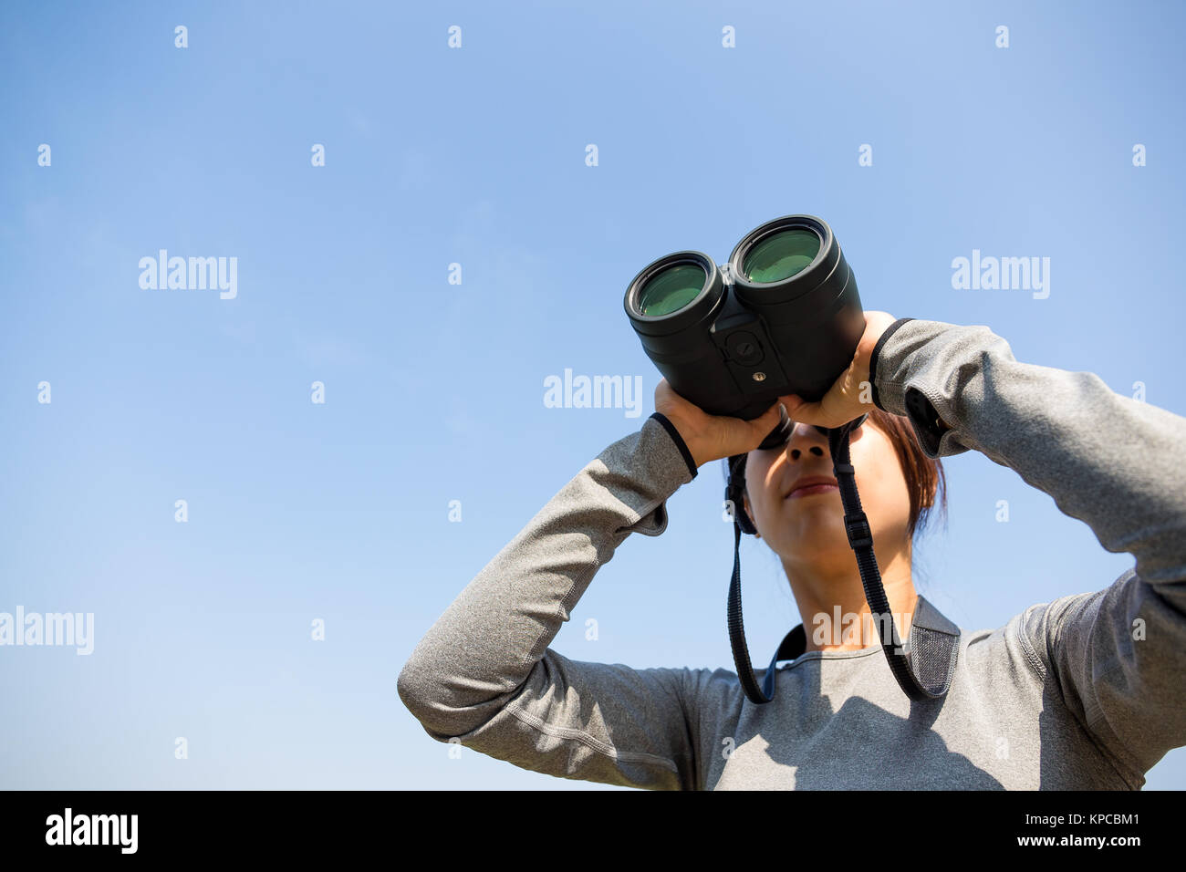 Woman use of the binocular Stock Photo - Alamy