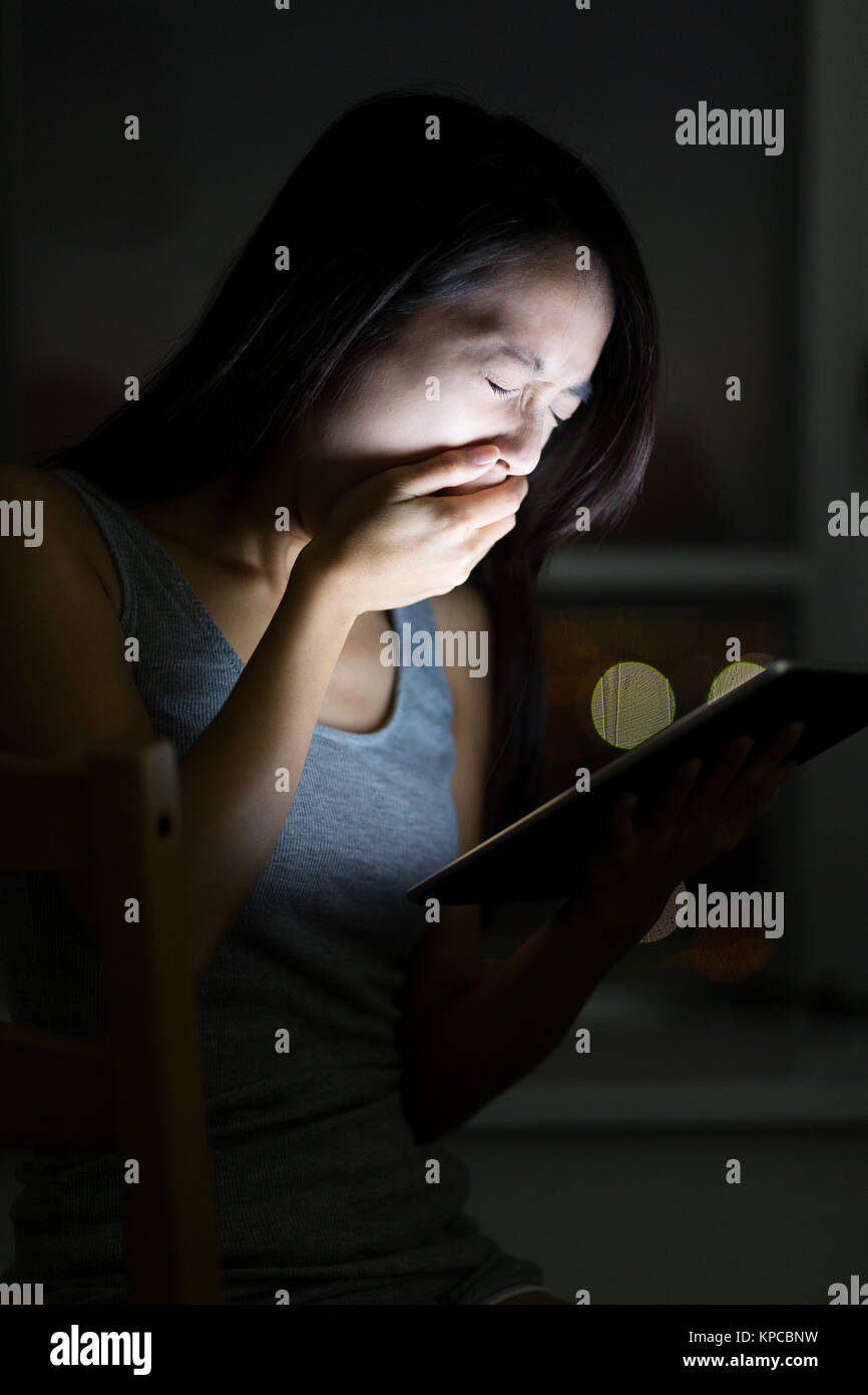 Young Woman feeling tired when use of the tablet pc Stock Photo - Alamy