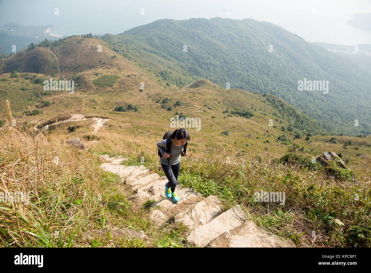 Asian woman hiker climb mountain Stock Photo - Alamy