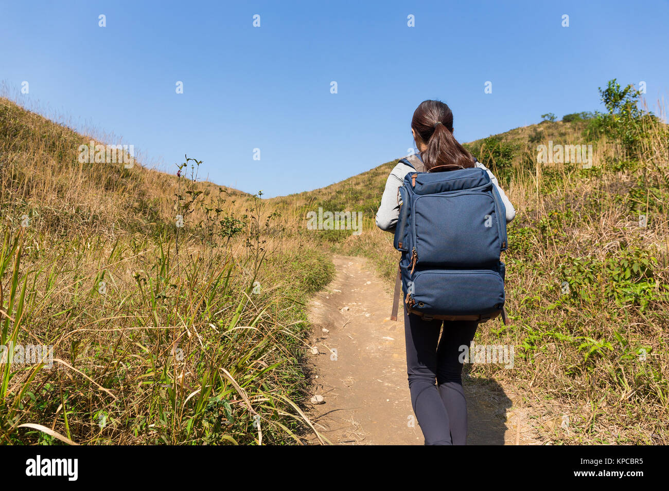 The back view of Woman go hiking Stock Photo - Alamy