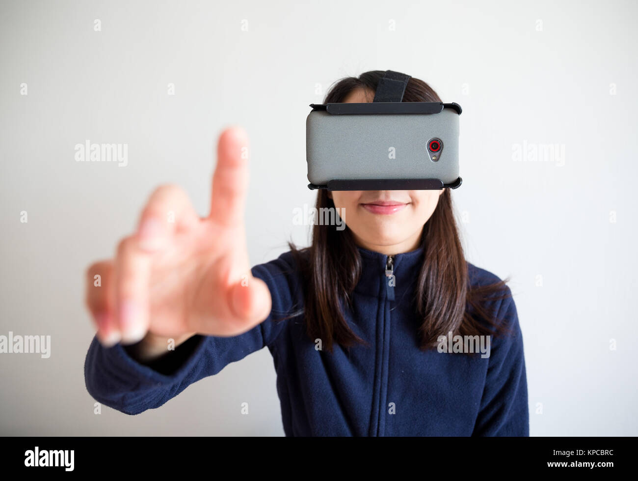 Woman look though vr device and touch on air Stock Photo - Alamy