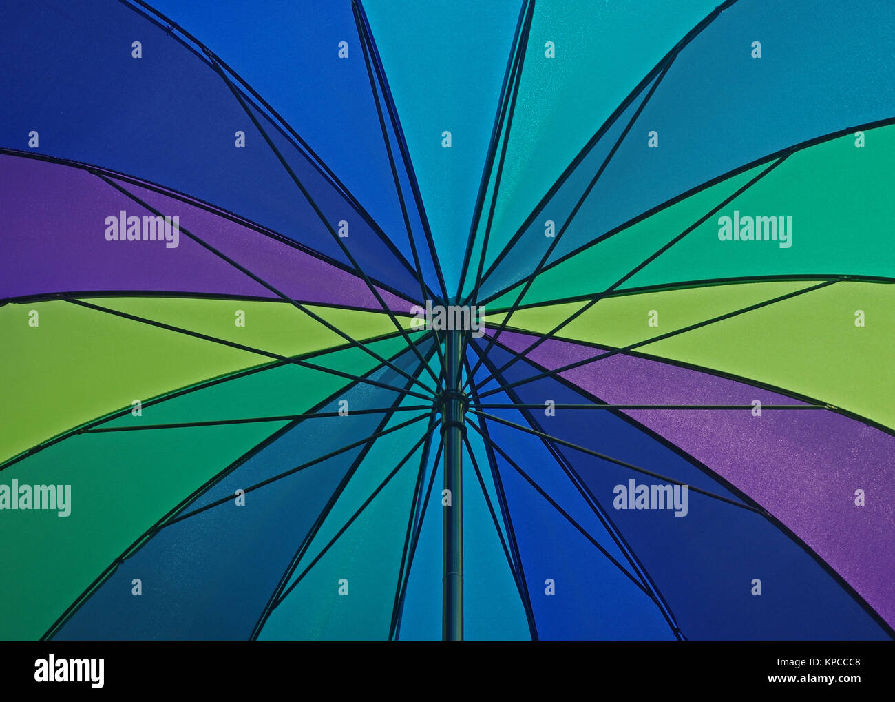 Detail of a colorful open umbrella watched from underneath while ...