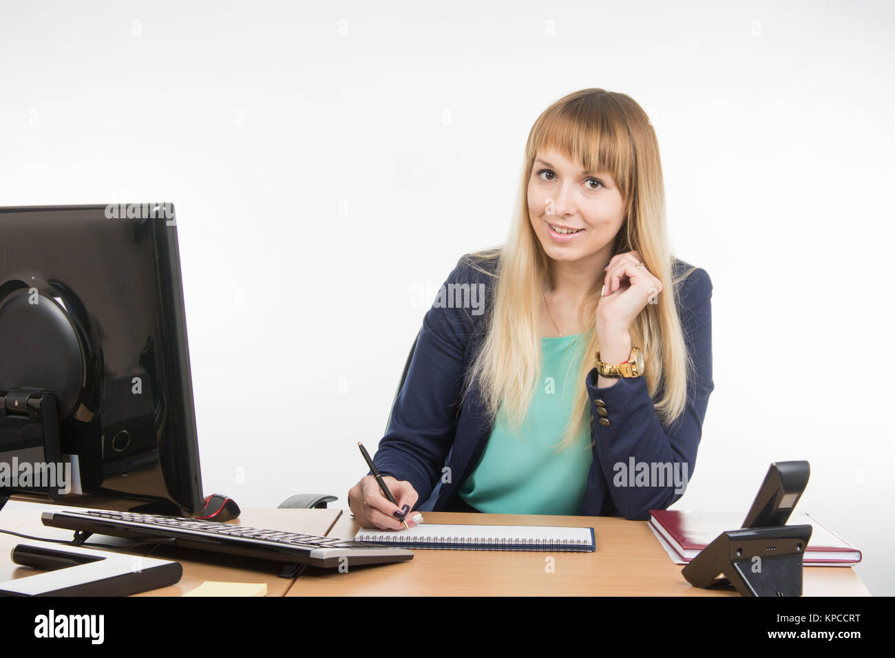 The secretary wrote a note in the diary and looked in the frame Stock ...