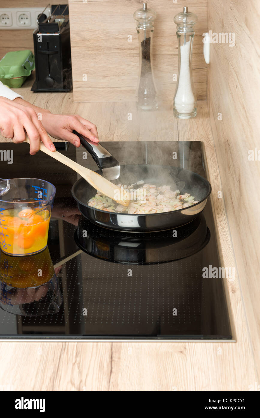 Ready for breakfast: cooking scrambled eggs in a modern kitchen Stock ...