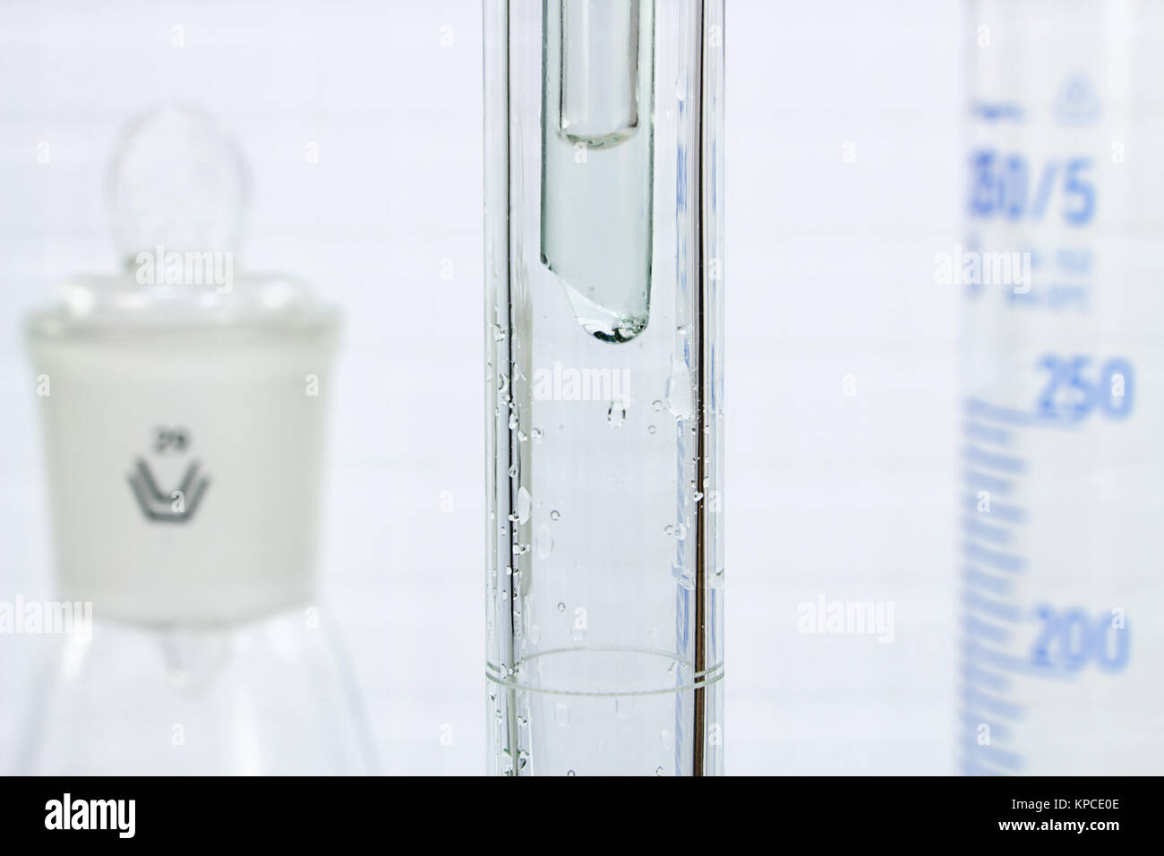 Falling of the drops of solution in glass test tubes Stock Photo - Alamy