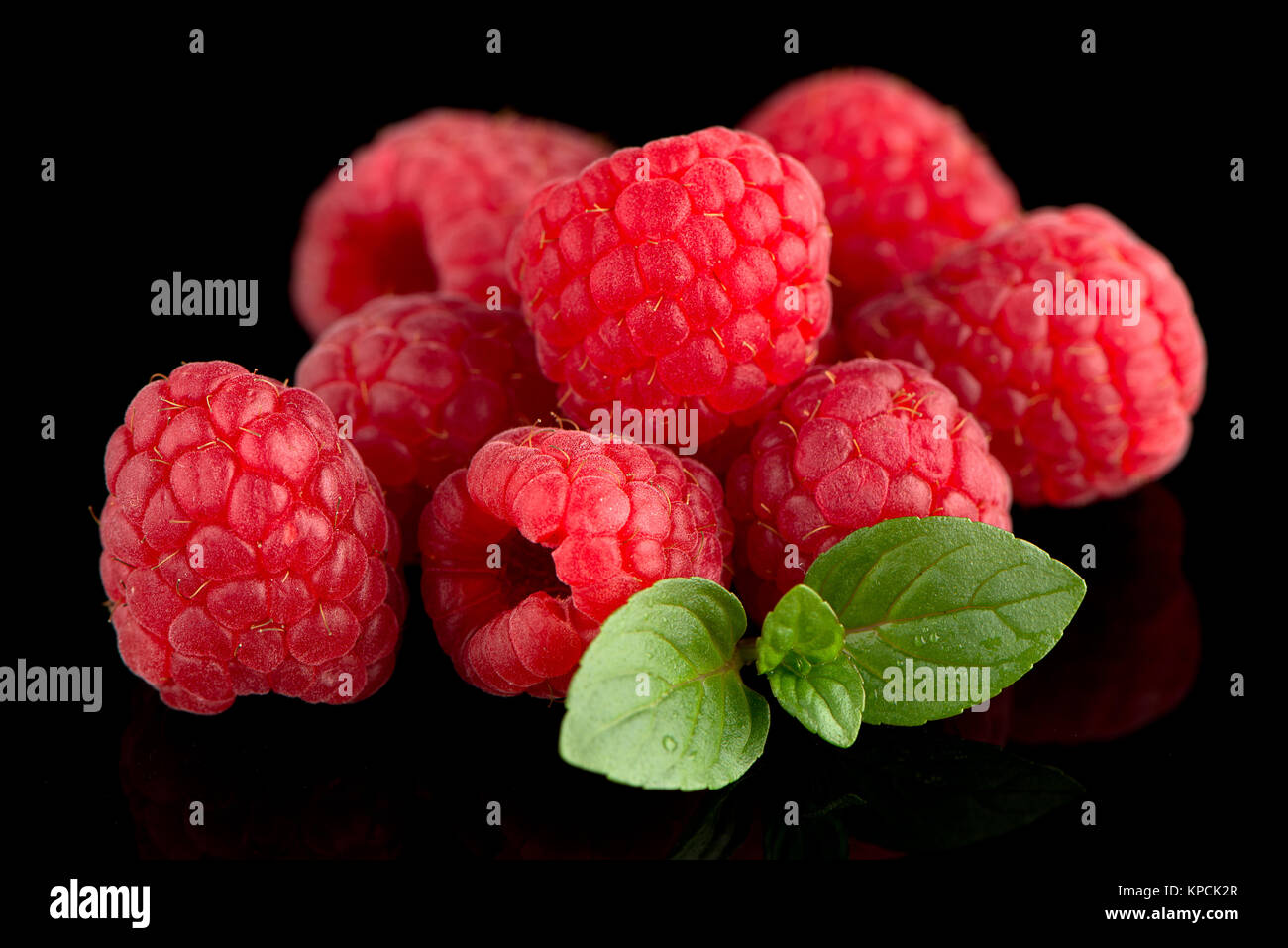 Raspberries with leaves Stock Photo - Alamy