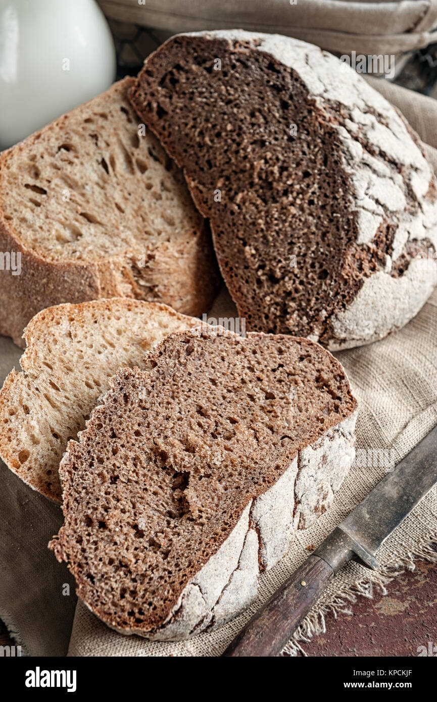 A beautiful loaf of rye farm sourdough bread is handmade. Close-up ...
