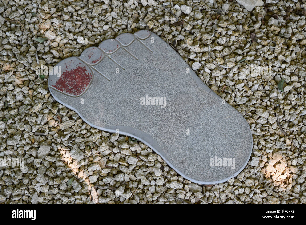 Tile in the form foot of person Stock Photo - Alamy