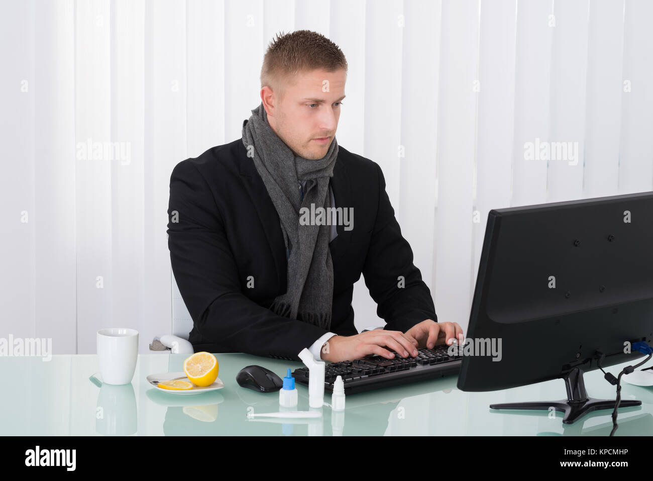 Sick Businessman Using Computer In Office Stock Photo - Alamy