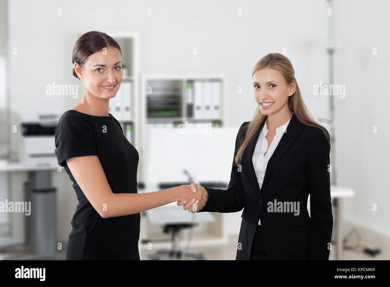 Business women shaking hands making a deal Stock Photo - Alamy