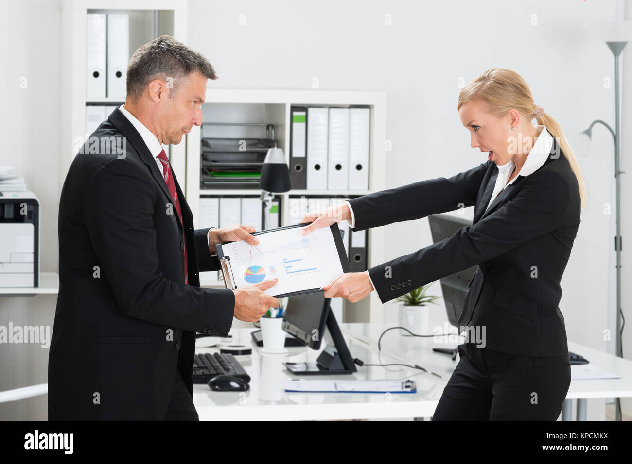 Business People Snatching Project In Office Stock Photo - Alamy