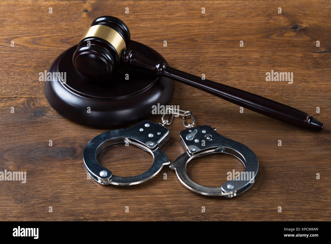 Mallet And Handcuffs On Table In Courtroom Stock Photo - Alamy