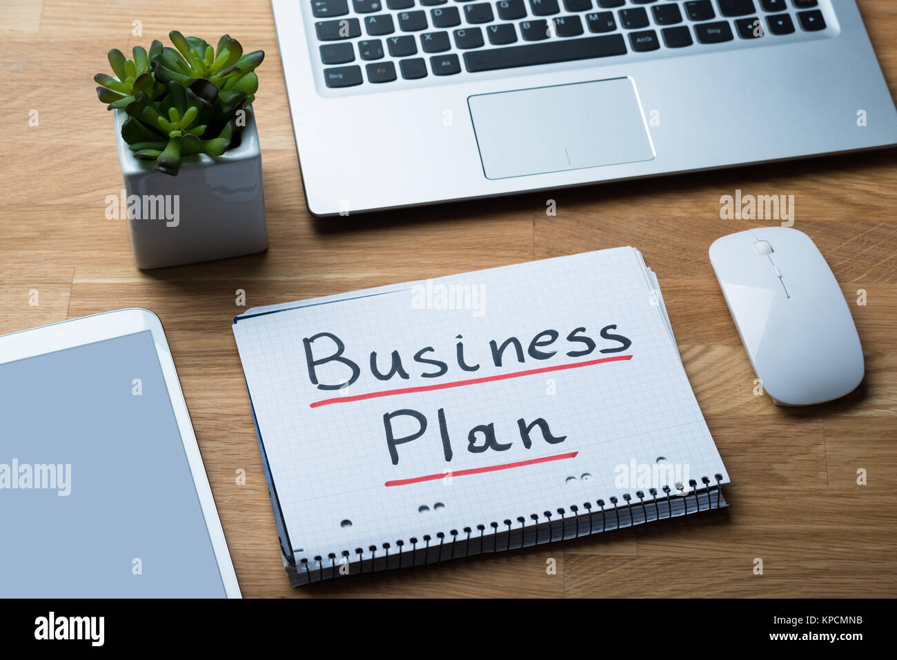 Business Plan Written On Notepad At Office Desk Stock Photo - Alamy