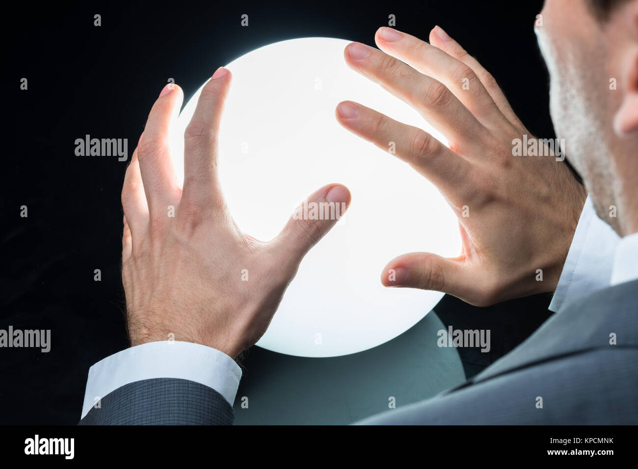 Businessman Predicting Future On Crystal Ball Stock Photo - Alamy
