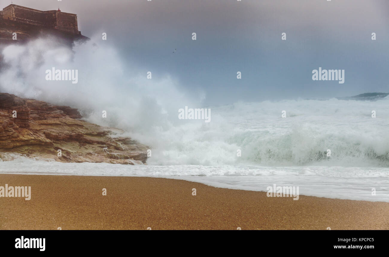 storm waves roll over the beach and clap on rocks Stock Photo - Alamy