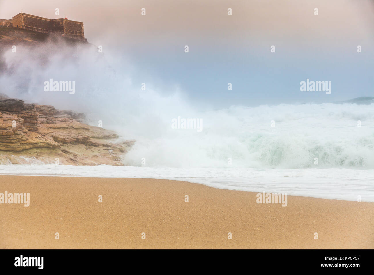 storm waves roll over the beach and clap on rocks Stock Photo - Alamy
