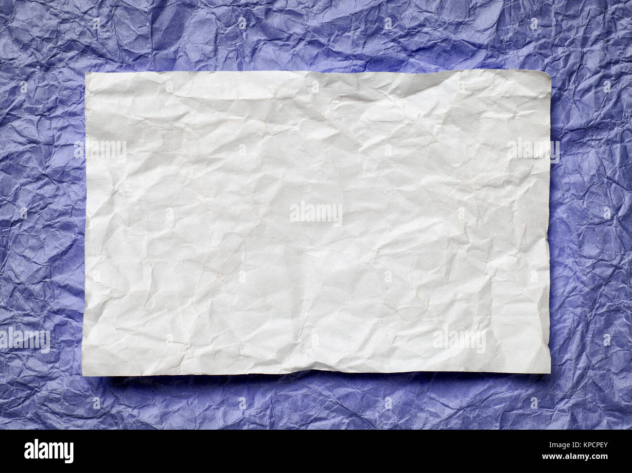 paper card on violet background Stock Photo - Alamy