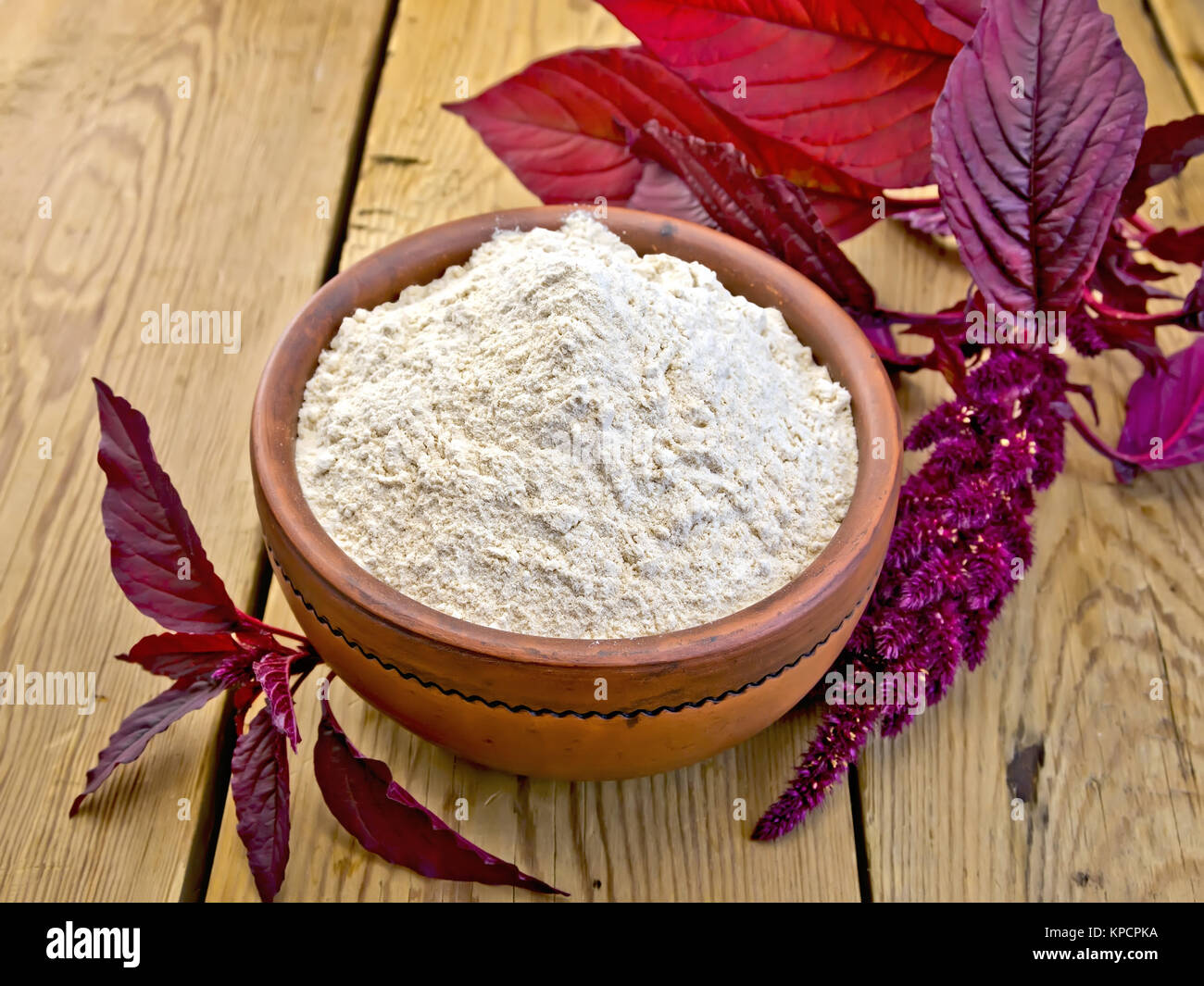 Flour amaranth in clay bowl on board with flower Stock Photo - Alamy