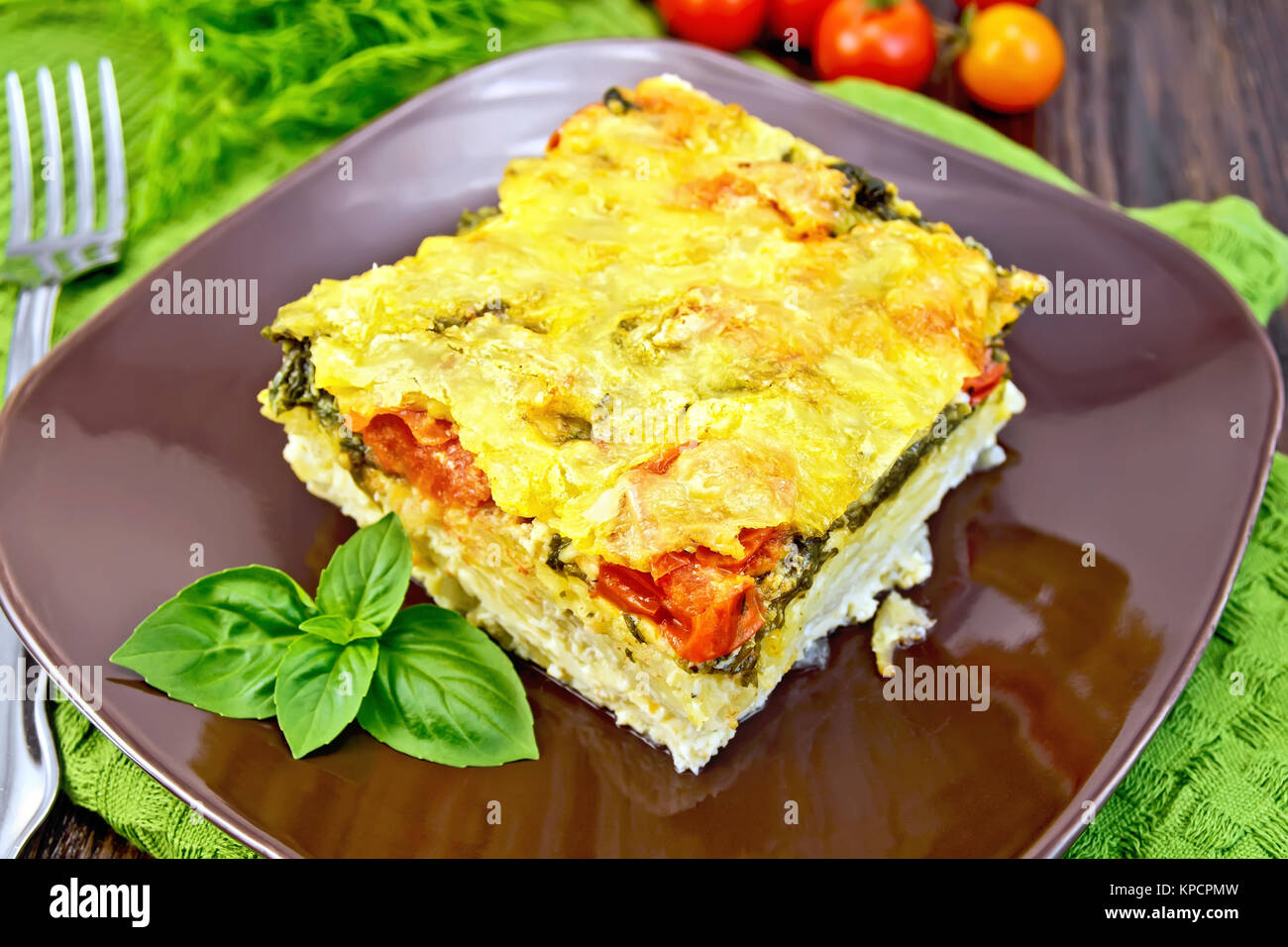 Pie potato with tomato and basil on board Stock Photo - Alamy