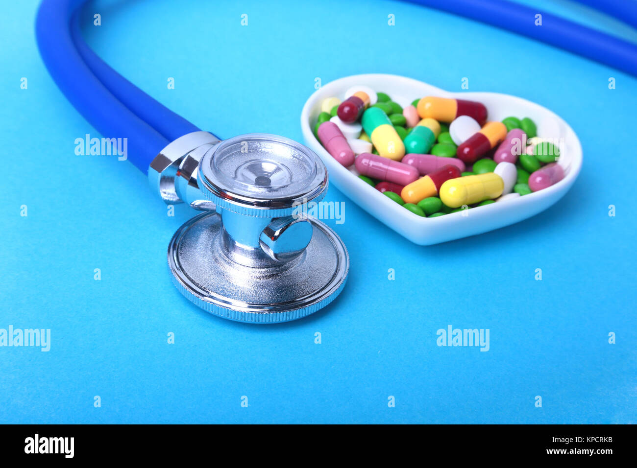Stethoscope, RX prescription and colorful assortment pills and capsules ...