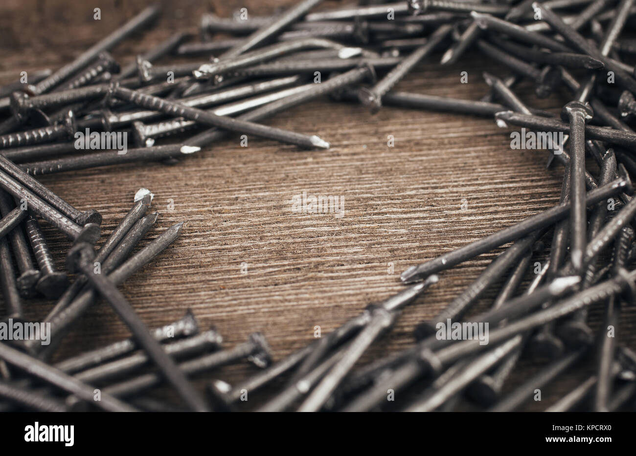 iron nails on wooden background Stock Photo - Alamy