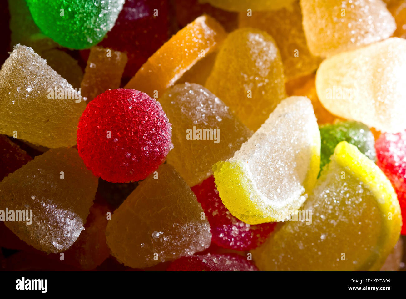 multicoloured fruit candies in the ray of light Stock Photo - Alamy
