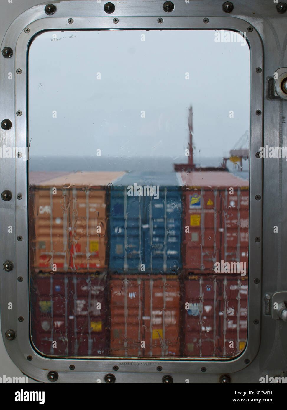 Shipping Containers on Ship's Deck Viewed Through Rain Streaked Window ...