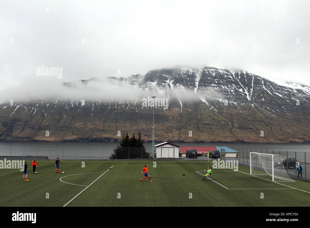 rural football field with mountains ice snow and water Stock Photo - Alamy
