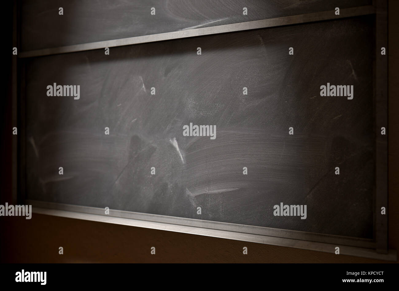 A closeup of a blank school chalk board on a dimly lit background - 3D ...