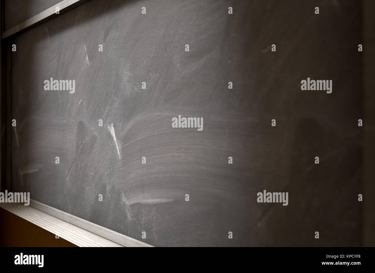 A closeup of a blank school chalk board on a dimly lit background - 3D ...