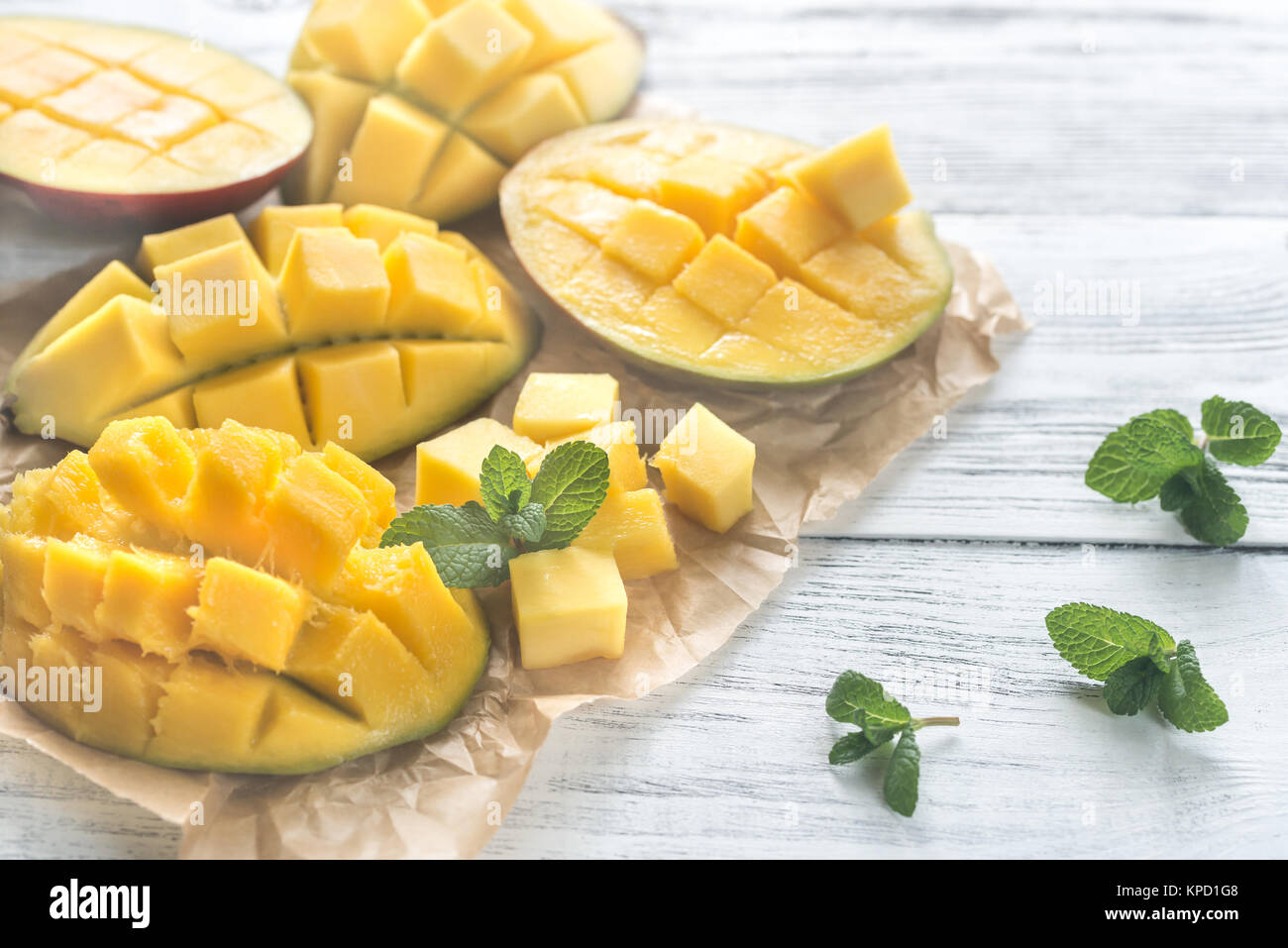 Halves of mango on the wooden background Stock Photo - Alamy