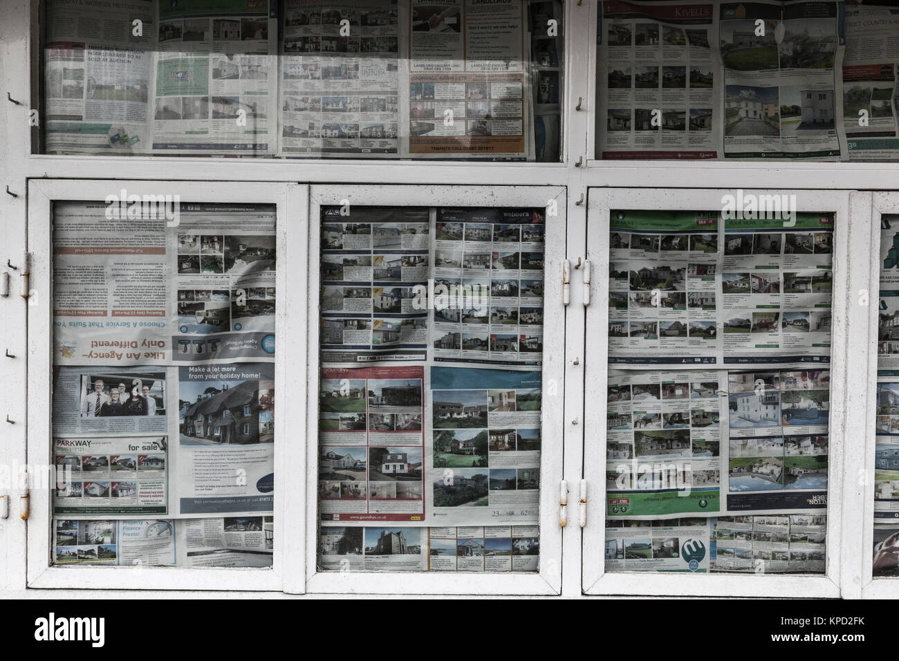The inside of a shop window is completely covered with newspaper Stock ...