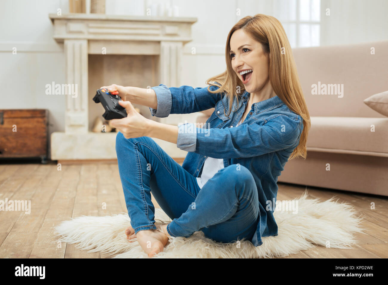 Happy woman playing a game Stock Photo - Alamy